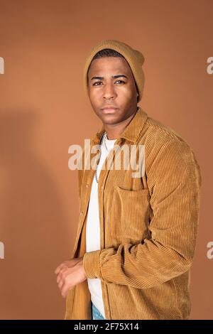 Studio shot of man against brown background Stock Photo - Alamy