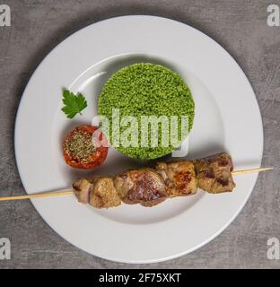 Lamb brochette marinated in spices, green semolina Stock Photo - Alamy