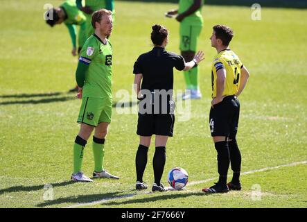 Referee Rebecca Welch (centre right) shows a yellow card to Fulham's ...