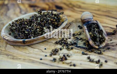 Andaliman pepper on olive wood Stock Photo - Alamy