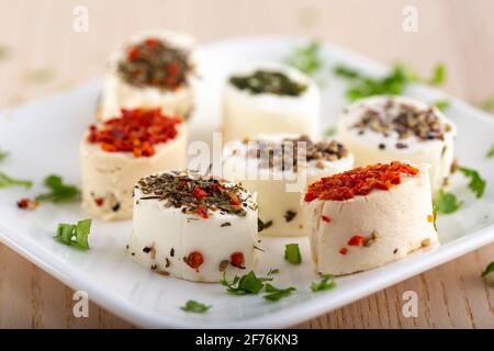 Small cheese appetizers with herbs and dried vegetables Stock Photo - Alamy