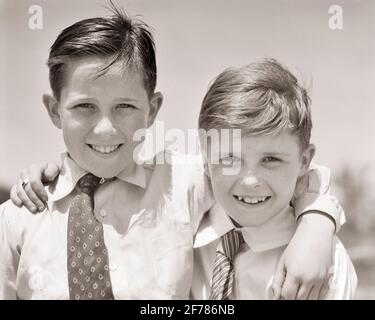 Two happy and friendly brothers hug each other, talk. Happy childhood ...