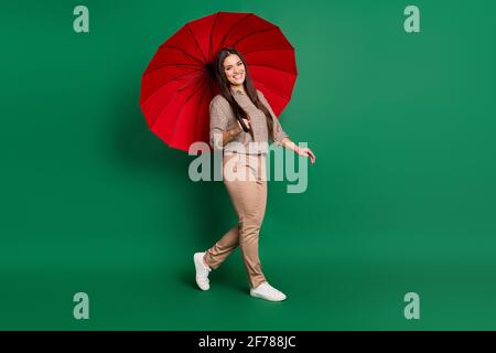 Photo of positive cute lady wear stylish purple clothes presenting ...