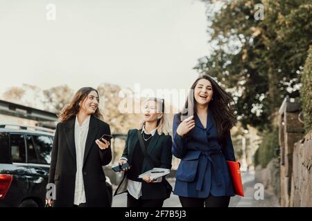 Female coworkers walking together Stock Photo - Alamy