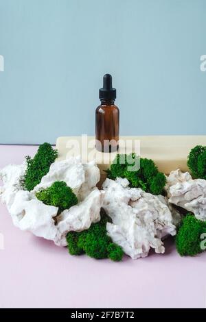 Blank amber glass face serum bottle on turquoise background. Abstract ...