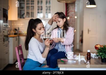 Small girl looking after her sick father Stock Photo - Alamy