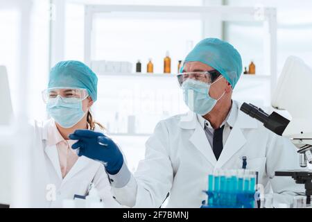 group of scientists discussing online data in the laboratory Stock ...