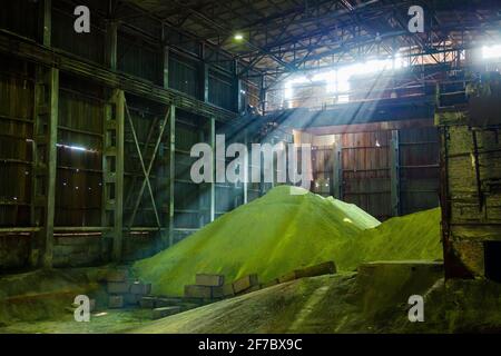 Heap of yellow dry sulphur on factory warehouse. Sulfuric acid ...