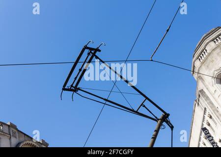 Tram overhead electrical wires in front of a building facade, Milan ...