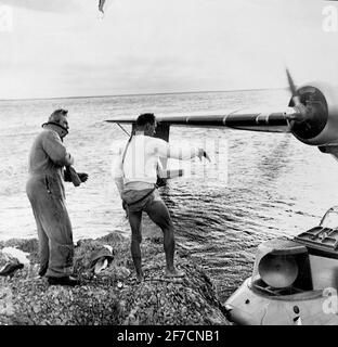 Mooring aircraft TP 47 Catalina by cliff at sea. Mooring aircraft TP 47 ...