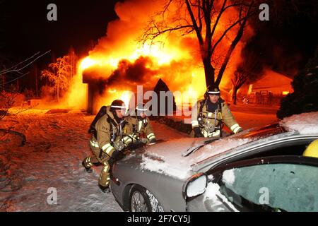 Firefighters during a fire late at night Stock Photo - Alamy