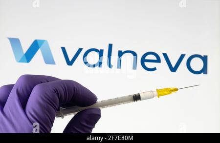 Valneva COVID-19 vaccine concept. Syringe and Valneva company logo on ...