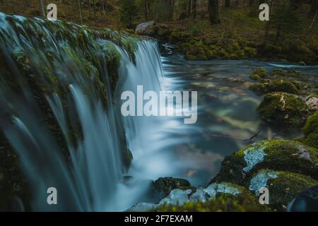 Small romantic waterfall in the middle of green forest Stock Photo - Alamy
