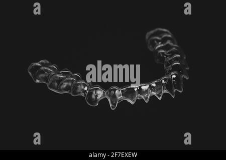 Orthodontic retainer made from transparent plastic in a blue carrying ...