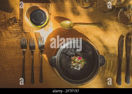 Fancy silverware, crockery, plates and other stuff on a table, with ...