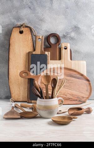 Cooking wooden utensils, empty plate, condiments and spices on stone ...