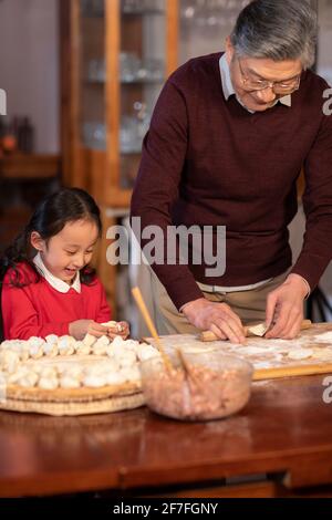 Happy family making dumplings Stock Photo - Alamy