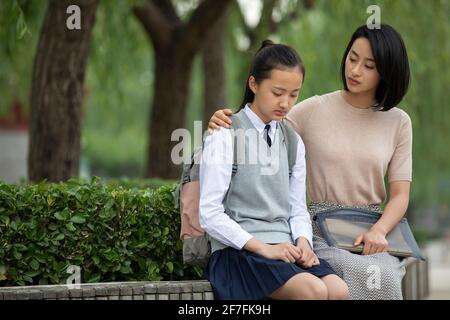 Teacher consoling student Stock Photo - Alamy