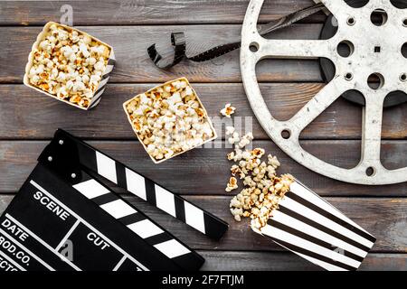 Layout of film reel with popcorn and clapperboard. Cinema concept Stock ...