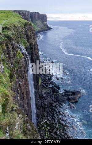 Aerial view of kilt rock waterfall cascading from a dramatic cliff into ...