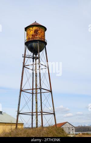 Old rusty or rusting water tower near railroad tracks now being used as ...