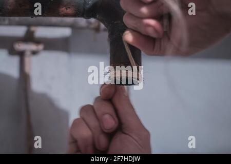 Sealing pipe connections with linum flax oakum or yarn. Professional ...