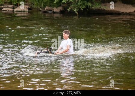 young gypsy traveller man on horse in river at Appleby Horse fair ...