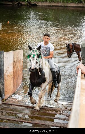 young gypsy traveller man on horse in river at Appleby Horse fair ...