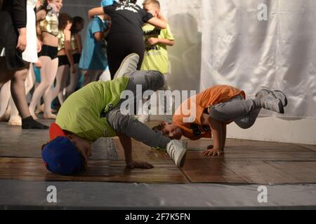 Boys dancing breakdance in frozen baby position. Baby freeze breakdance ...