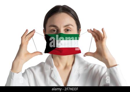Respirator with flag of Kuwait Doctor puts on medical face mask ...