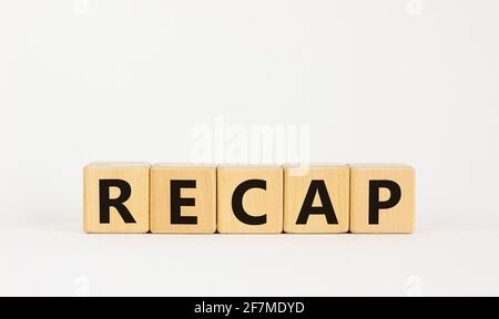Recap symbol. The word 'recap' on wooden cubes on beautiful grey dark ...