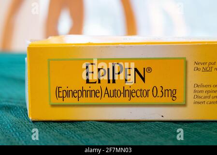 Close-up of an 'EpiPen' logo on a yellow epinephrine autoinjector box ...
