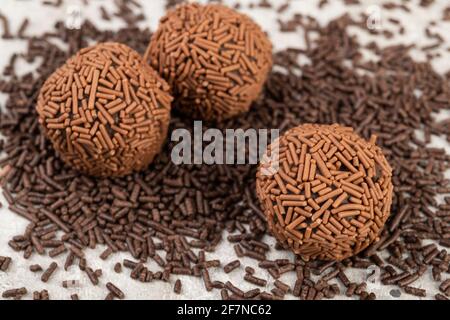 Typical brazilian brigadeiros with chocolate sprinkles over wooden ...