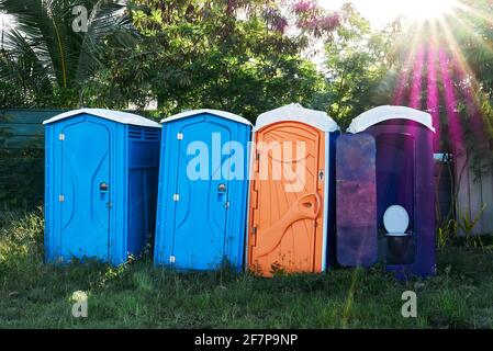 A Dirty, Blue portable Toilet in a Park, nasty looking place to go to ...