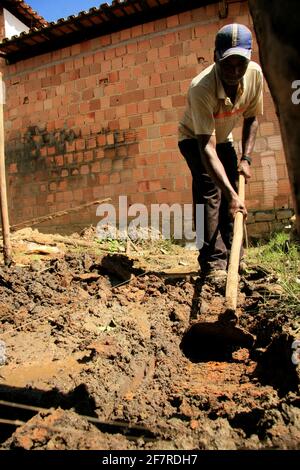 guaratinga, bahia, brazil - may 7, 2009: worker uses hoe to dig in land ...