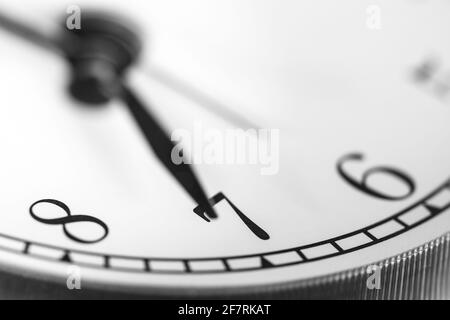 Classic analog clock pointing at seven forty five o'clock, isolated on ...