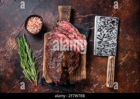 Roasted hanging tender or Onglet sliced beef meat steak on a butcher ...