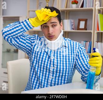 Man with neck unjury cleaning house in housekeeping concept Stock Photo ...