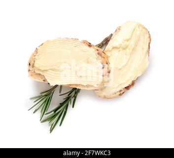 Slices of fresh bread with butter and rosemary on grunge background ...