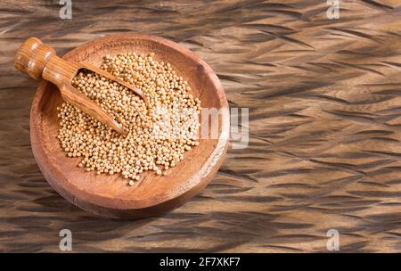 Sinapis alba - Organic yellow mustard seeds in wooden bowls Stock Photo ...
