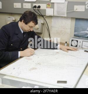 A Meteo officer at work with subscribing to a weather map Stock Photo ...