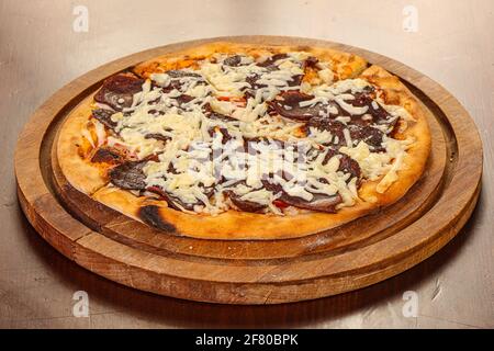 Pizza with dry beef meat and cheese Stock Photo - Alamy