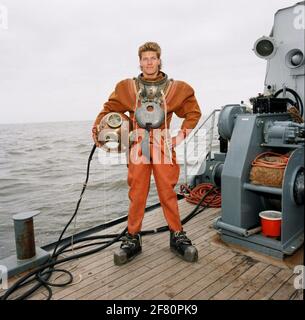 A diver in a standard diving suit on board the diving vessel HR. Ms ...