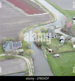 Aerial view of a farm, a mill without blades and a pumping station ...
