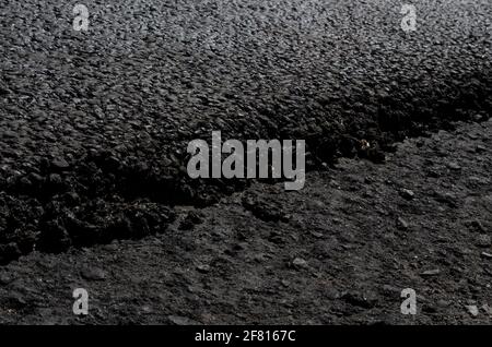 Structure of granular asphalt. Asphalt texture with two yellow line ...