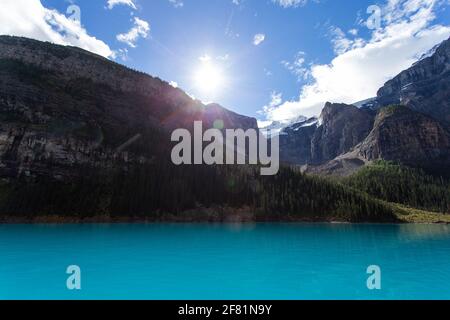 high peak behind a bright turquoise lake in a sunny summer day Stock ...