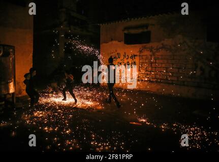 Gaza, Palestine. 10th Apr, 2021. Palestinian children play on a bicycle ...