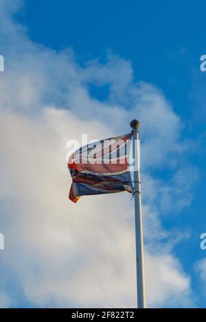 Ragged and frayed union flag (Union jack) against a pure white (cut out ...
