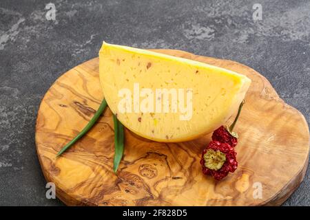 Hard cheese brick with walnut over board Stock Photo - Alamy