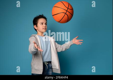 Teenage boy throwing a basketball isolated on white background Stock ...